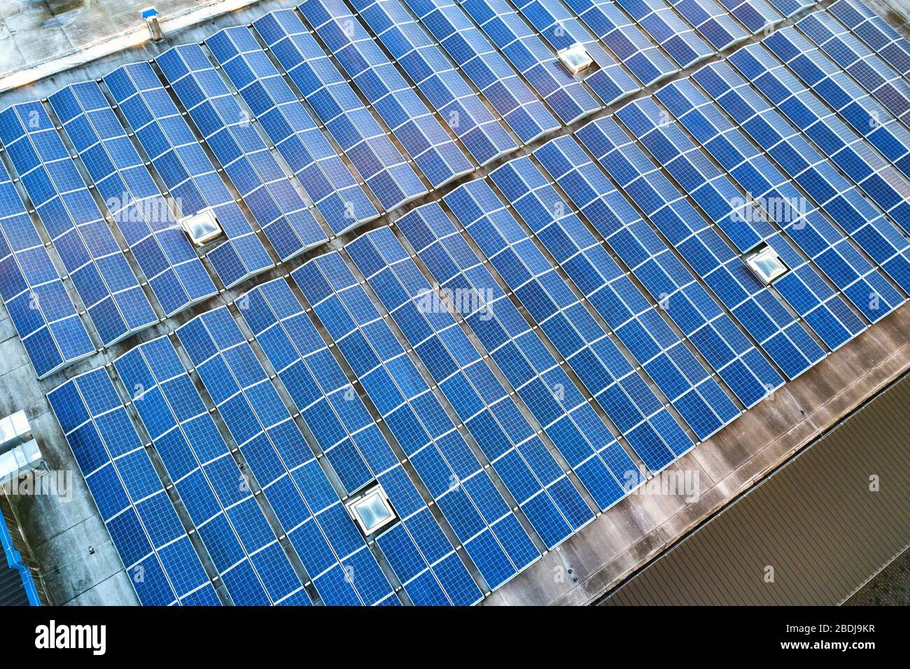 Aerial view of many photo voltaic solar panels mounted of industrial ...