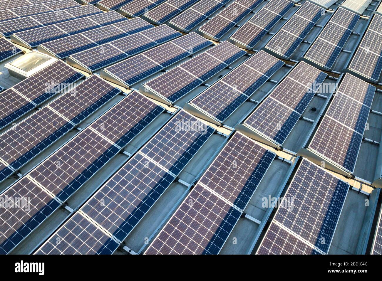Aerial view of many photo voltaic solar panels mounted of industrial ...