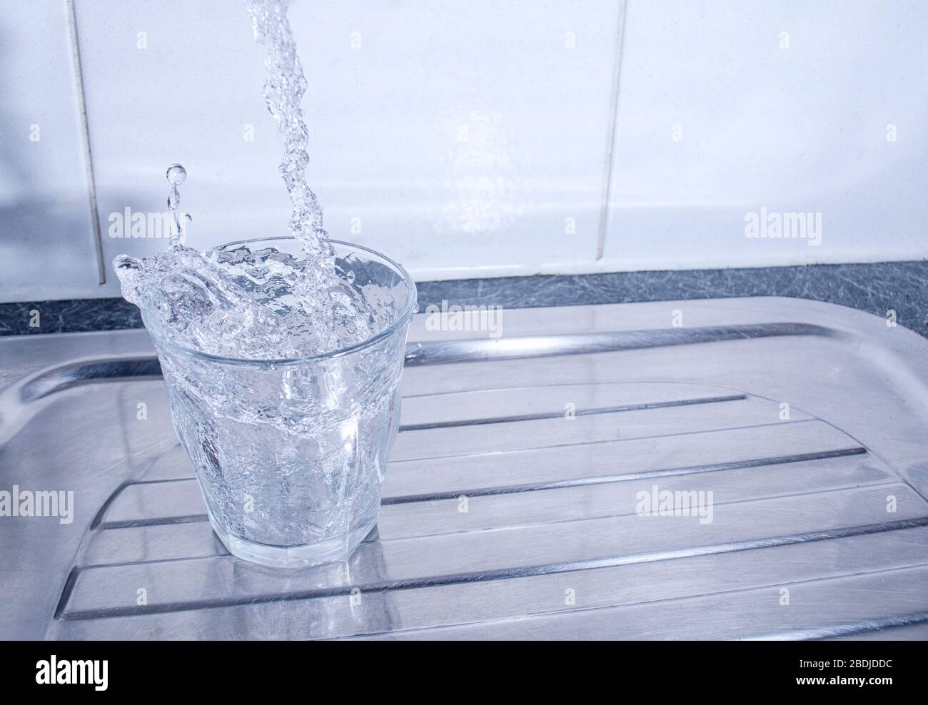 Clear Water Splashing Into A Glass Stock Photo - Alamy