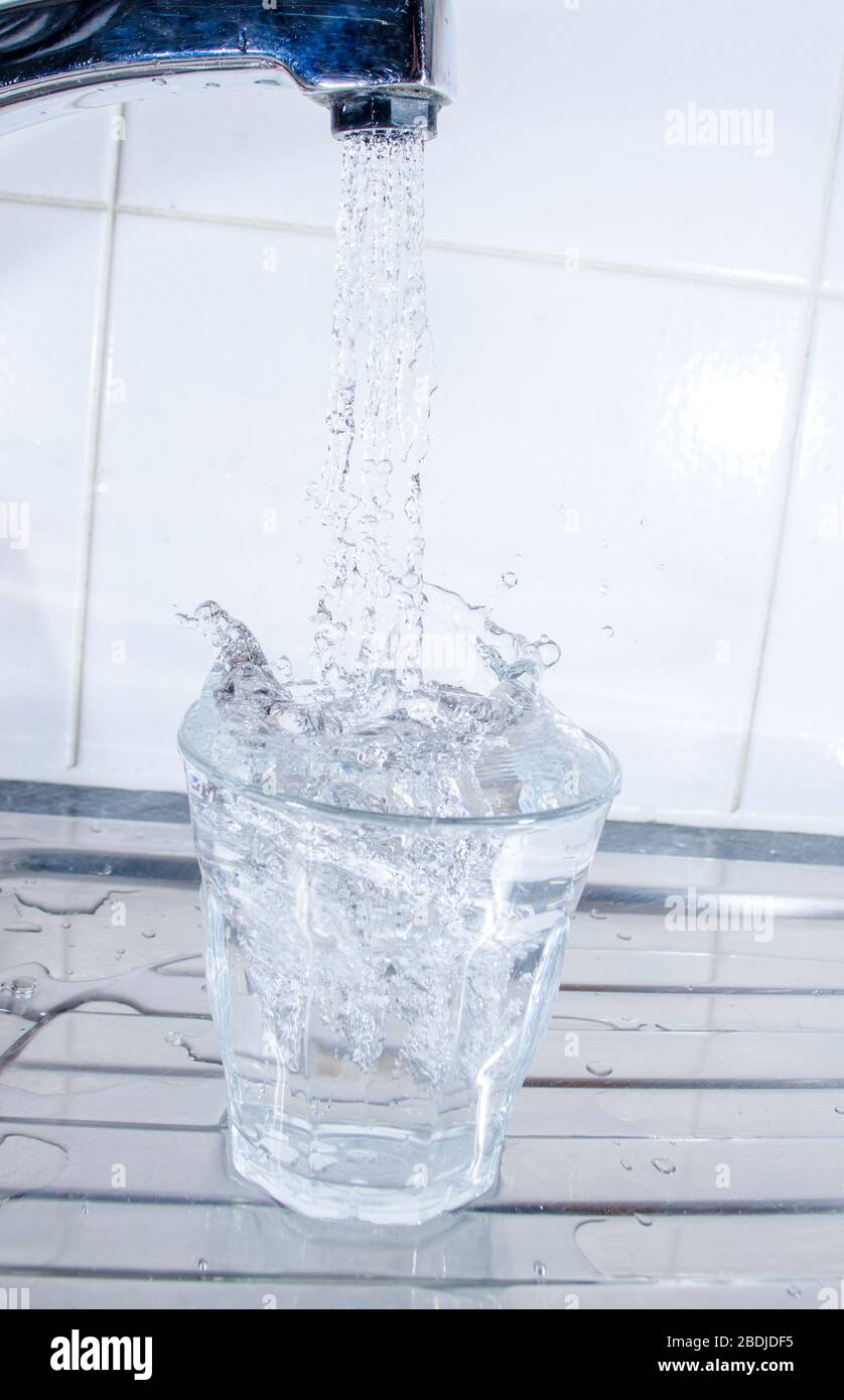 Clear Water Splashing Into A Glass Stock Photo - Alamy