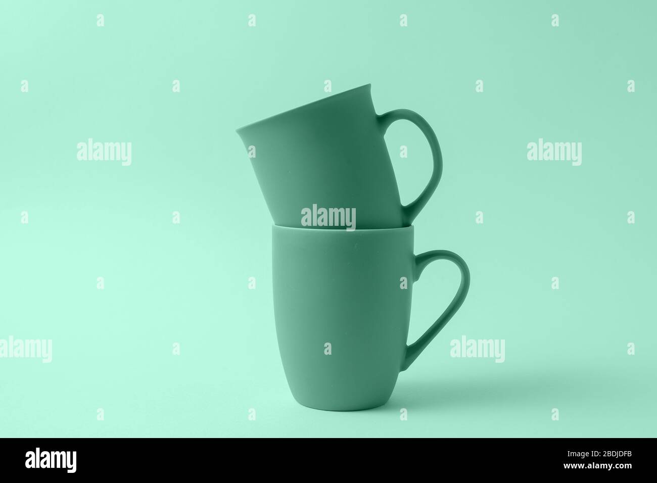 Flat lay Stack with mugs toned in light mint color on light mint ...
