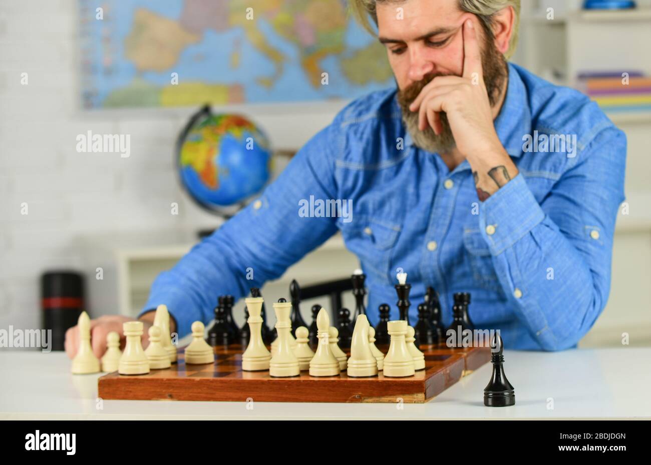 Figures on wooden chess board. Thinking about next step. Chess is ...