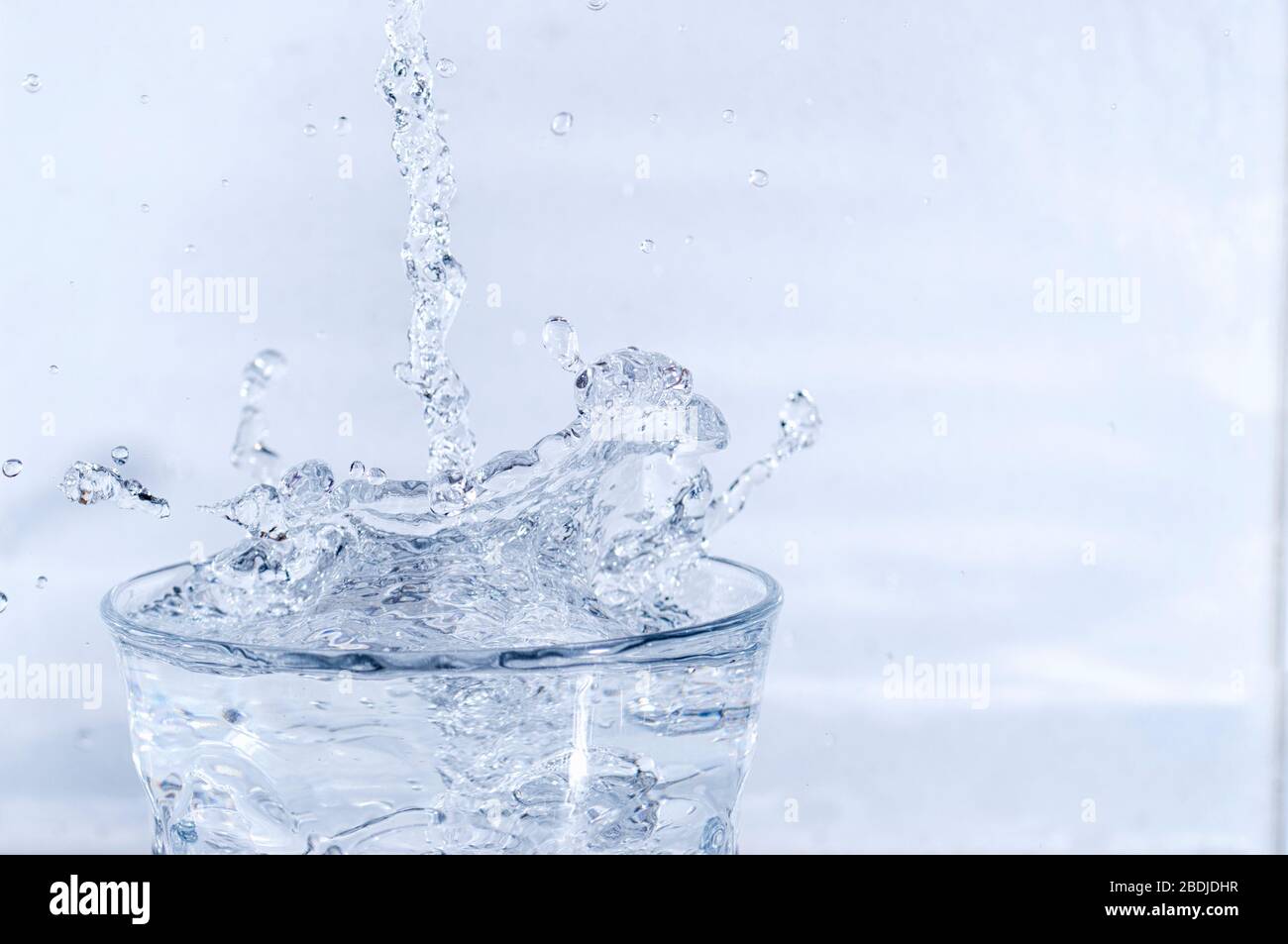 Clear Water Splashing Into A Glass Stock Photo - Alamy