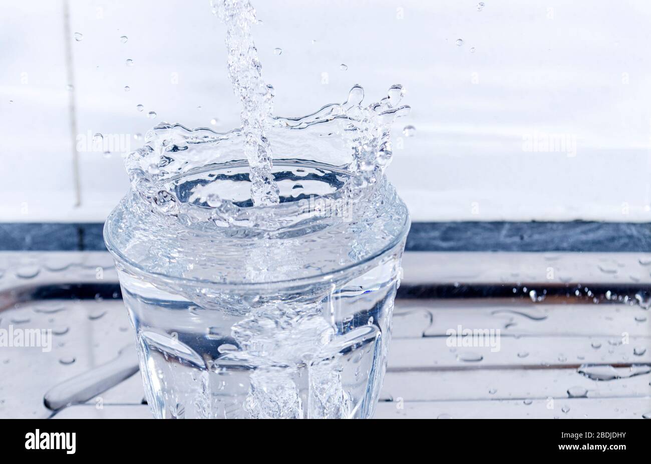 Clear Water Splashing Into A Glass Stock Photo - Alamy