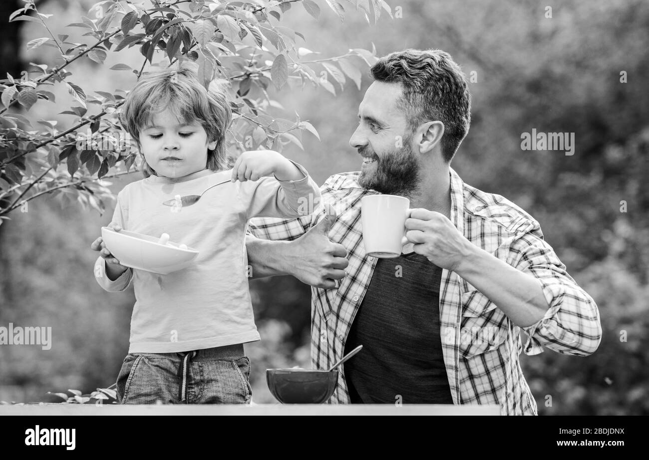 happy fathers day. Little boy with dad eat cereal. son and father ...