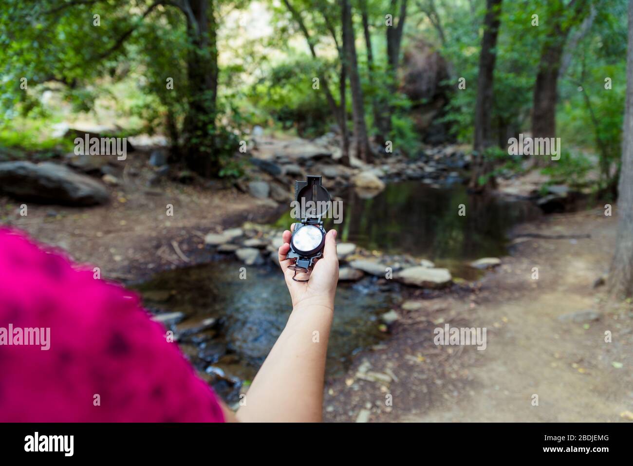 Beautiful landscape with old compass on traveler's hand. Traveling ...