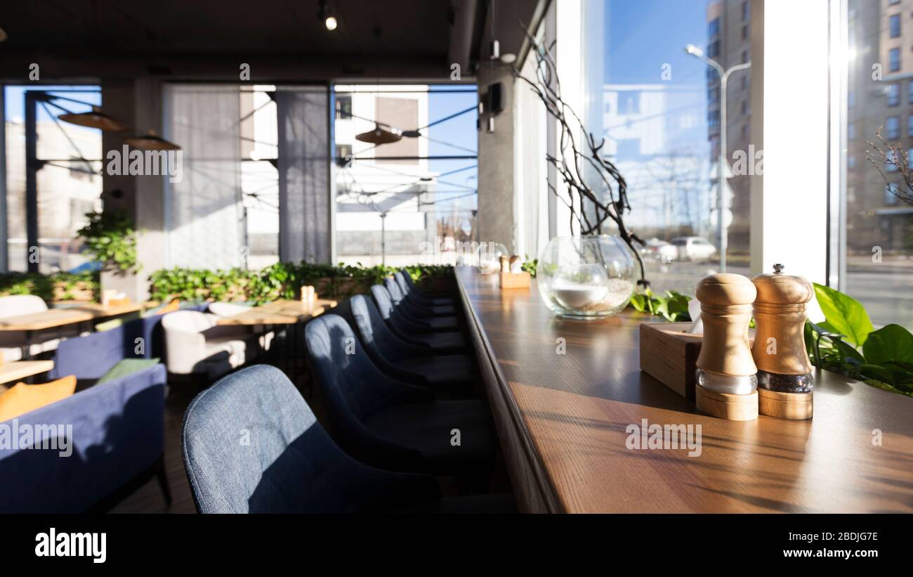 Sunny morning in modern cafe with big panoramic windows Stock Photo - Alamy