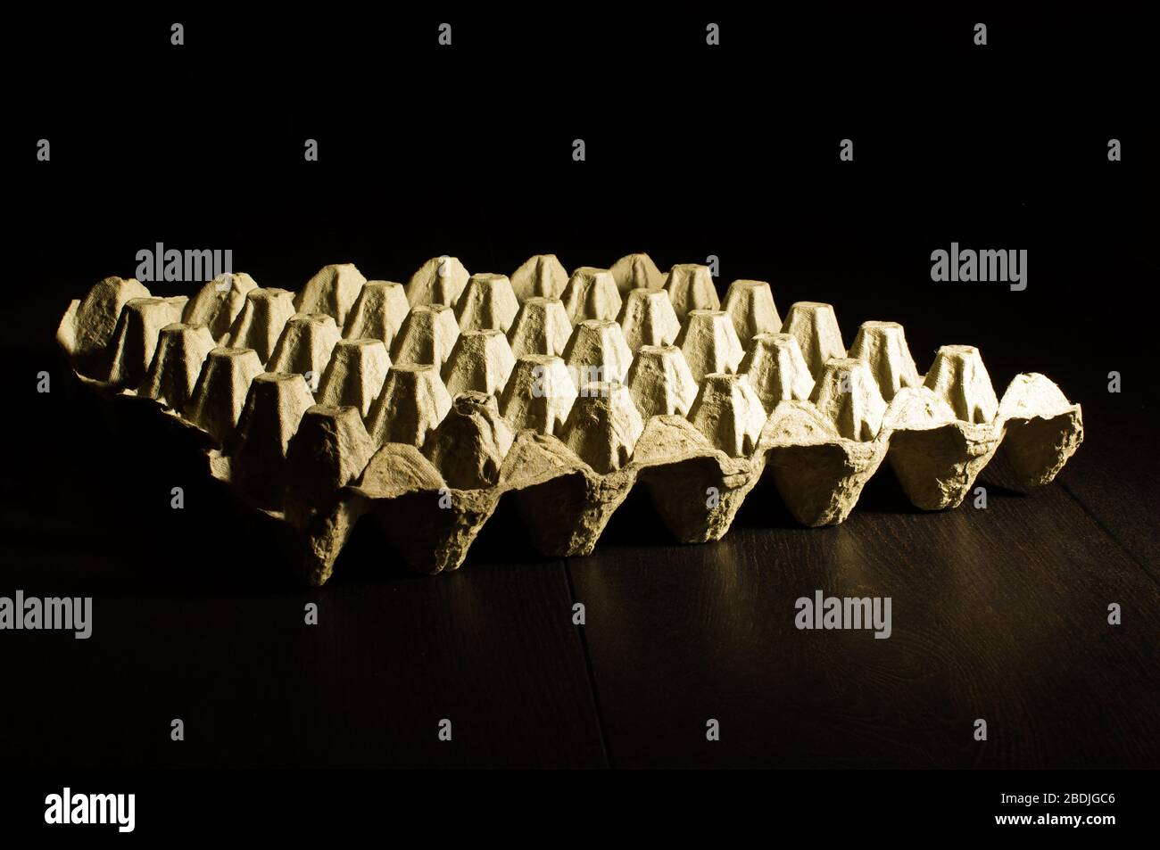 Egg case with dramatic lighting Stock Photo - Alamy