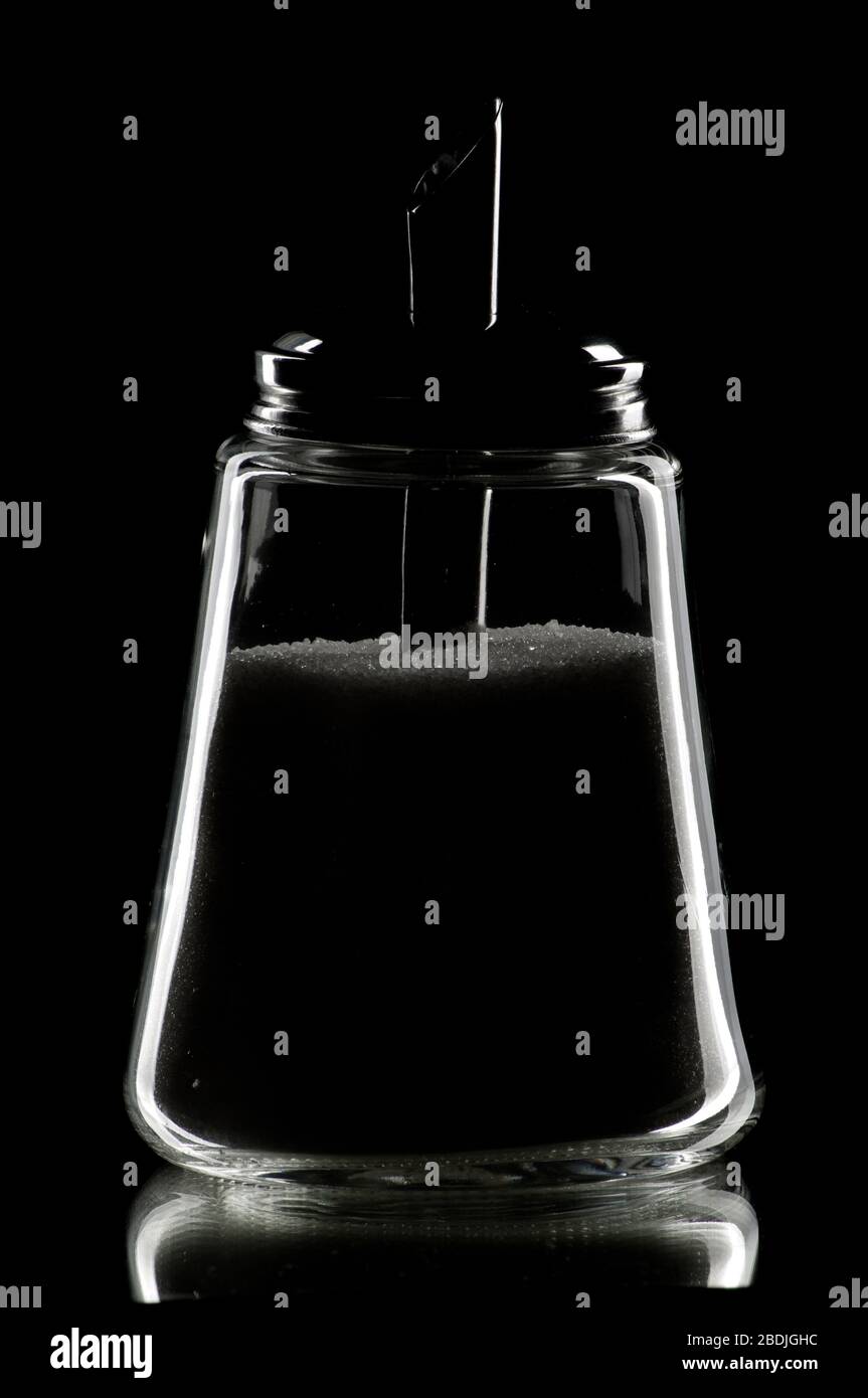 Sugar-basin with sugar backlit on the dark background Stock Photo - Alamy