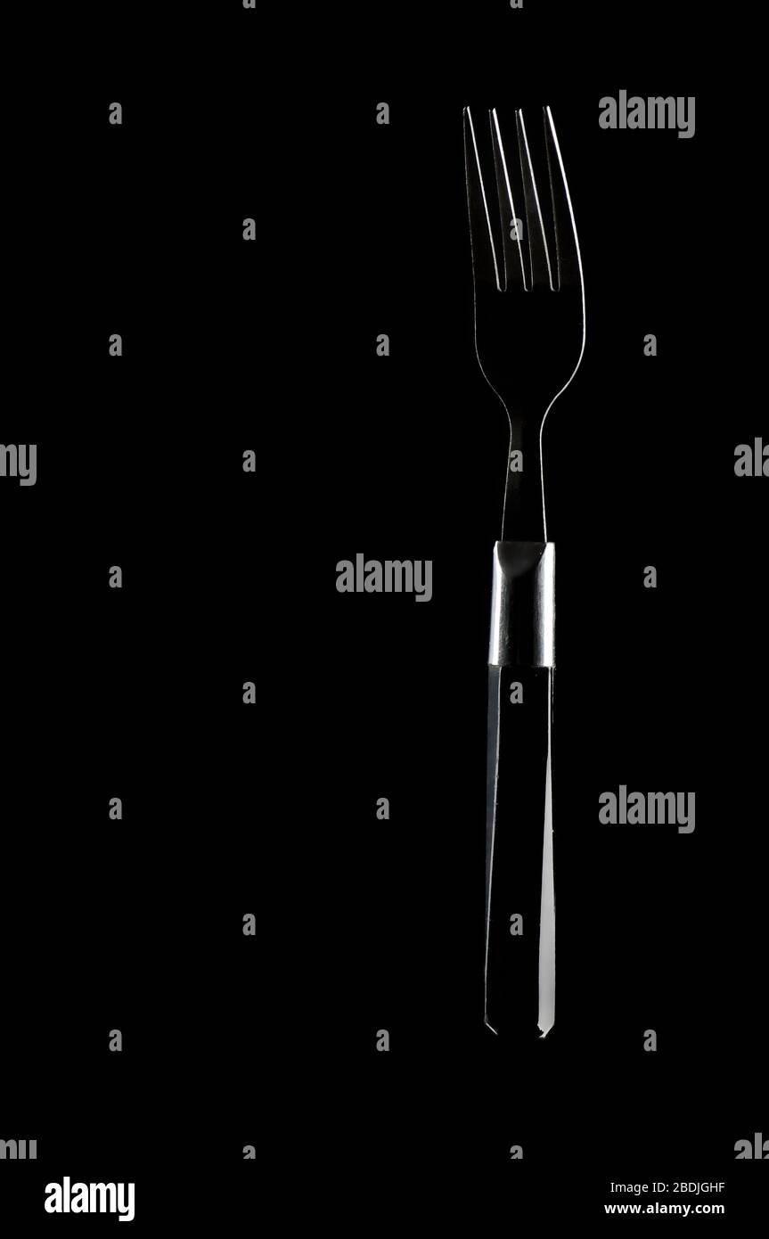 Close up fork on the black background Stock Photo - Alamy