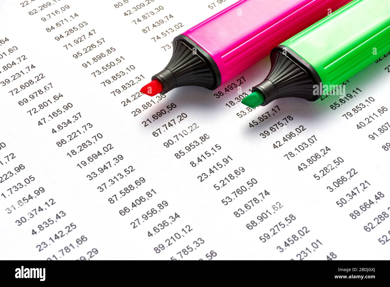 Red and geen marker on a white sheet of paper with printed financial ...