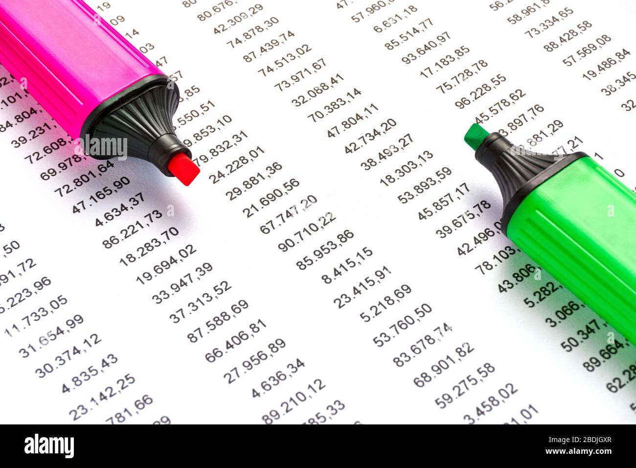 Red and geen marker on a white sheet of paper with printed financial ...