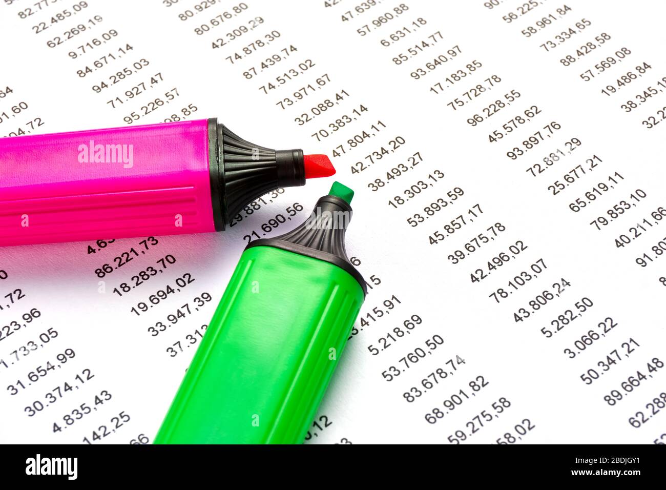 Red and geen marker on a white sheet of paper with printed financial ...