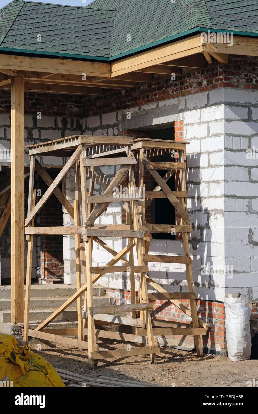 Small wooden scaffolding near the wall during the day, without people ...