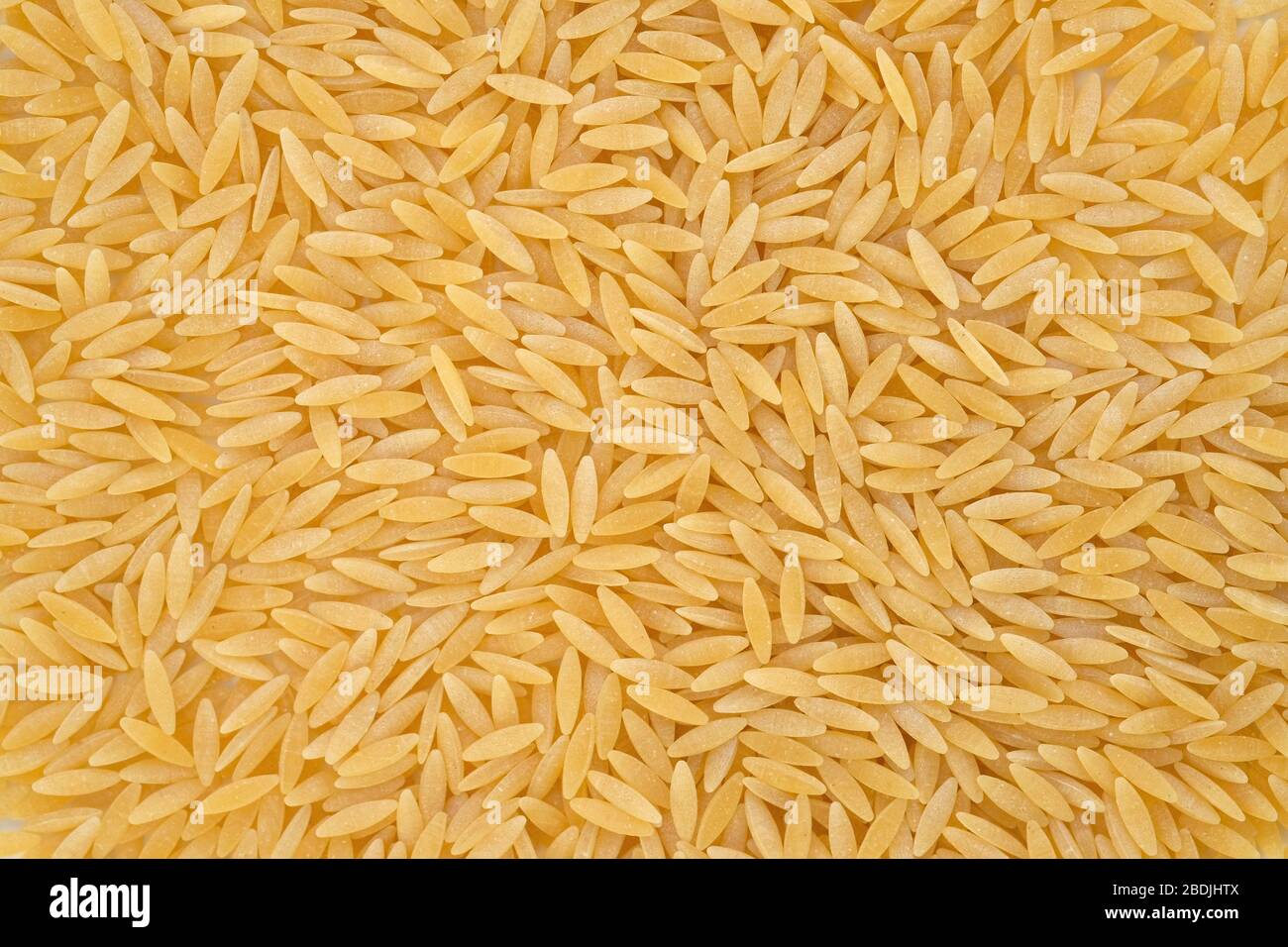 Italian pasta orzo background top view. Close-up of hard pasta in the ...