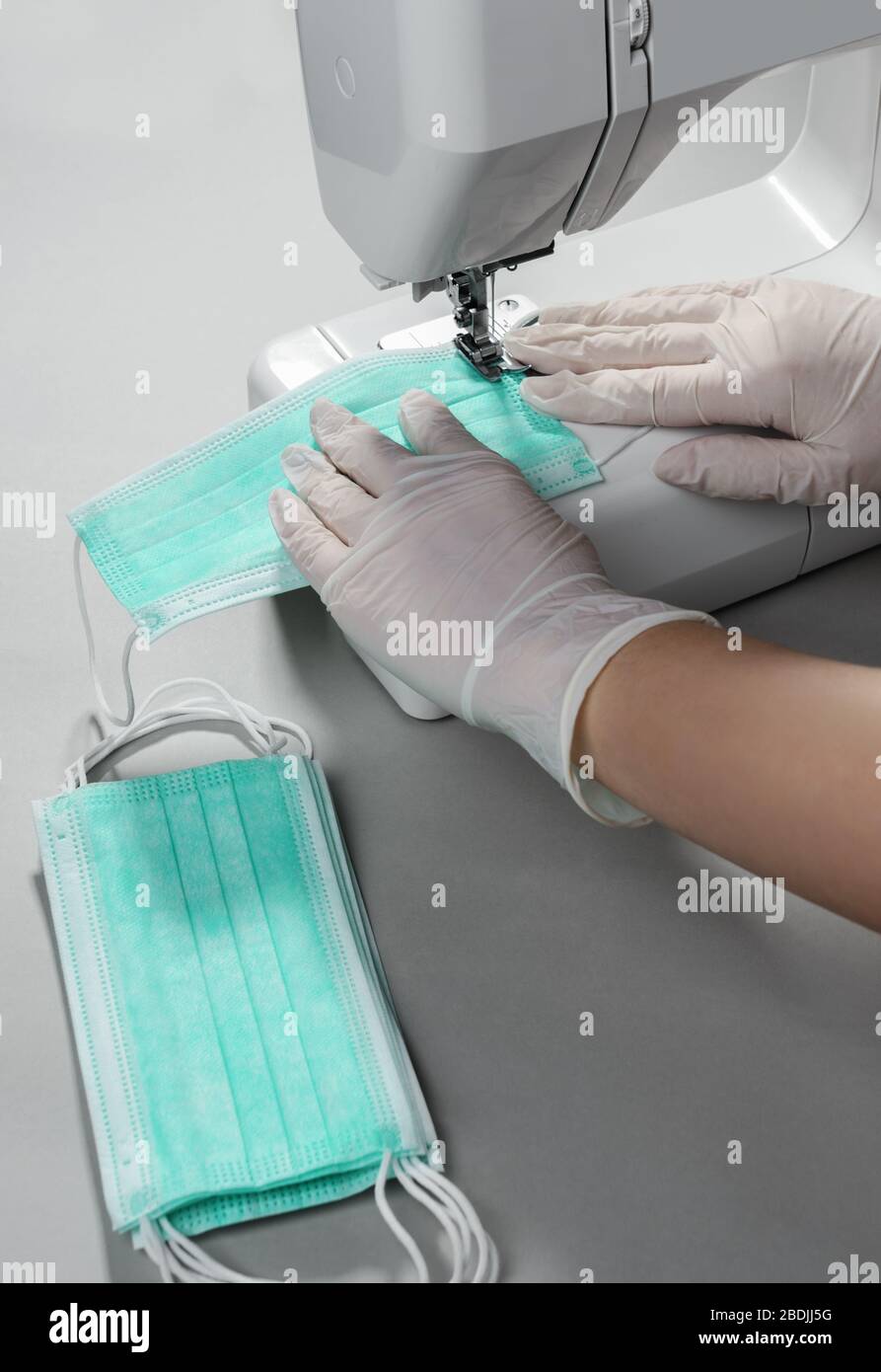 Making process of medical face masks by female worker wearing gloves ...