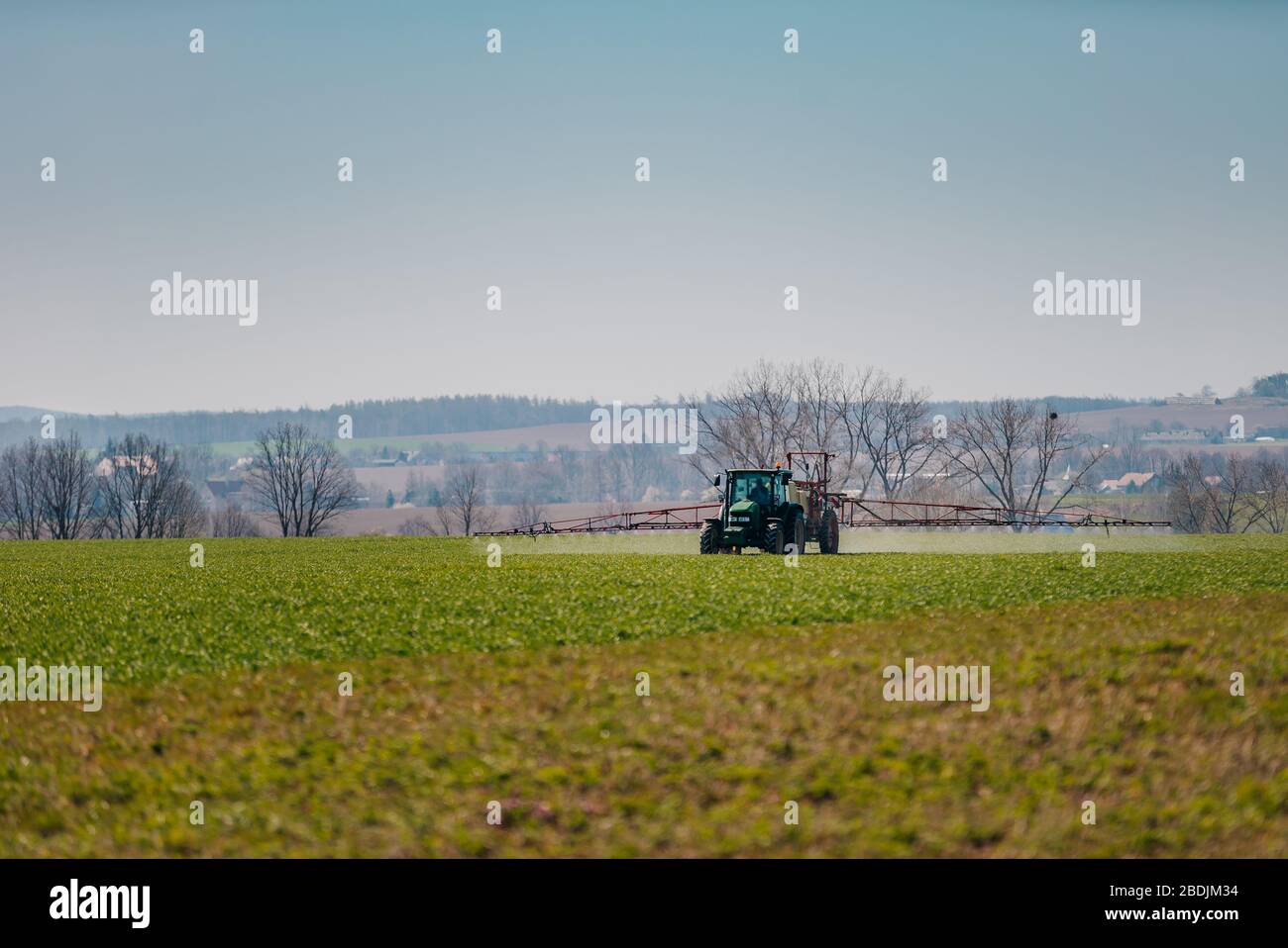 Agriculture Tractor Working in Field Stock Photo - Alamy