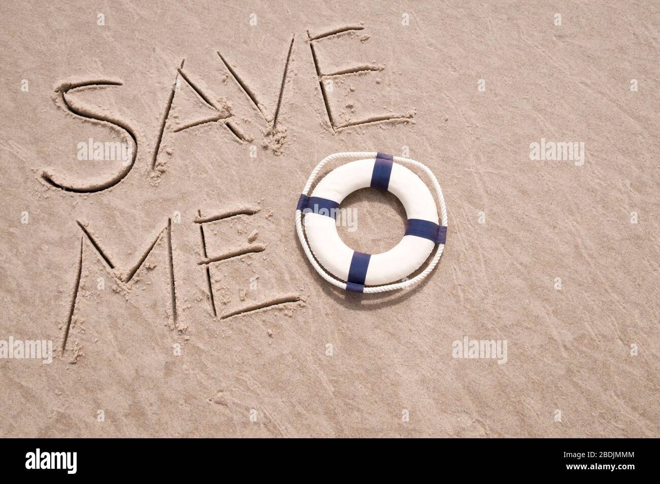 Save Me! message handwritten on the beach with lifesaver in smooth sand ...
