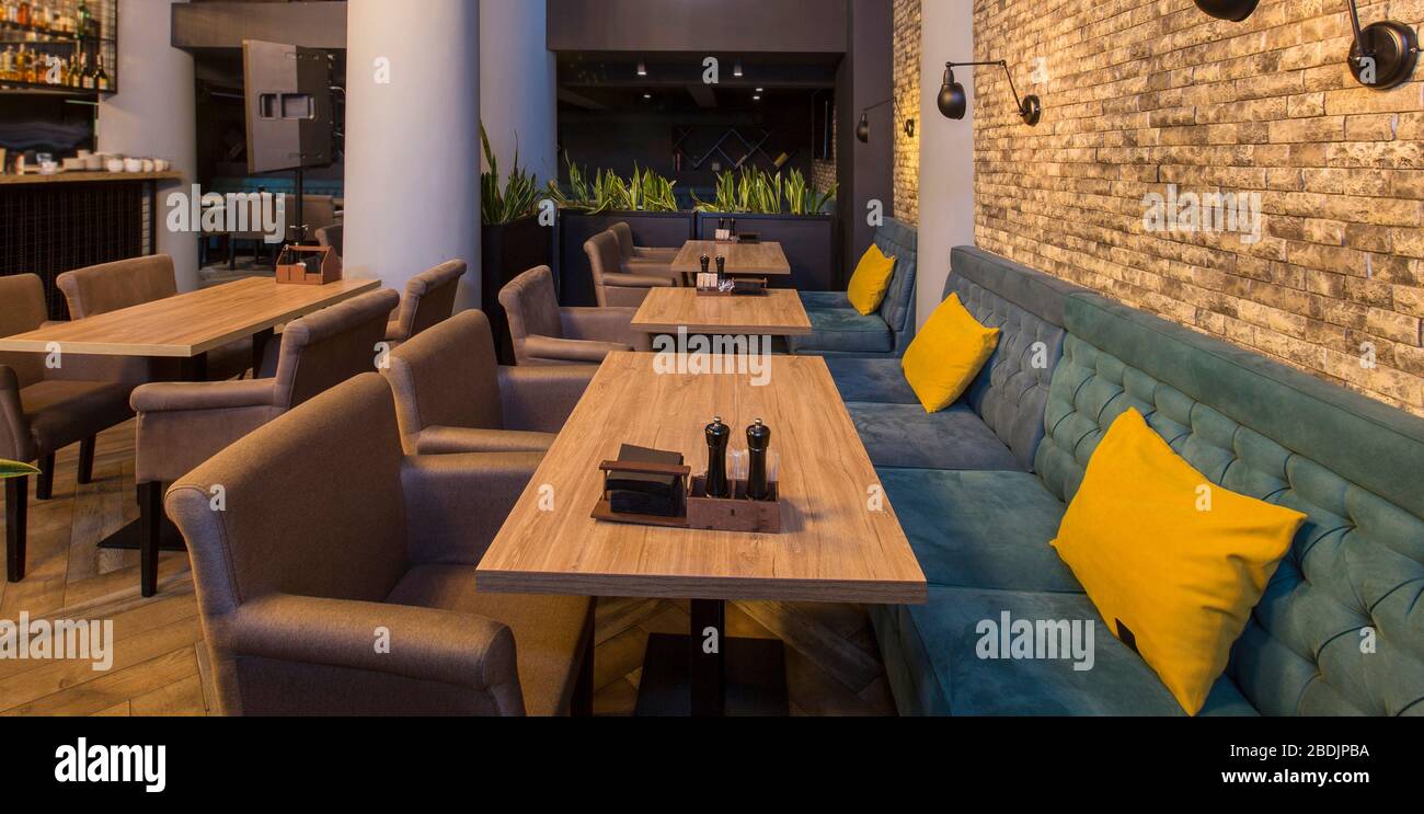Cute restaurant interior with sofas and wooden tables Stock Photo - Alamy