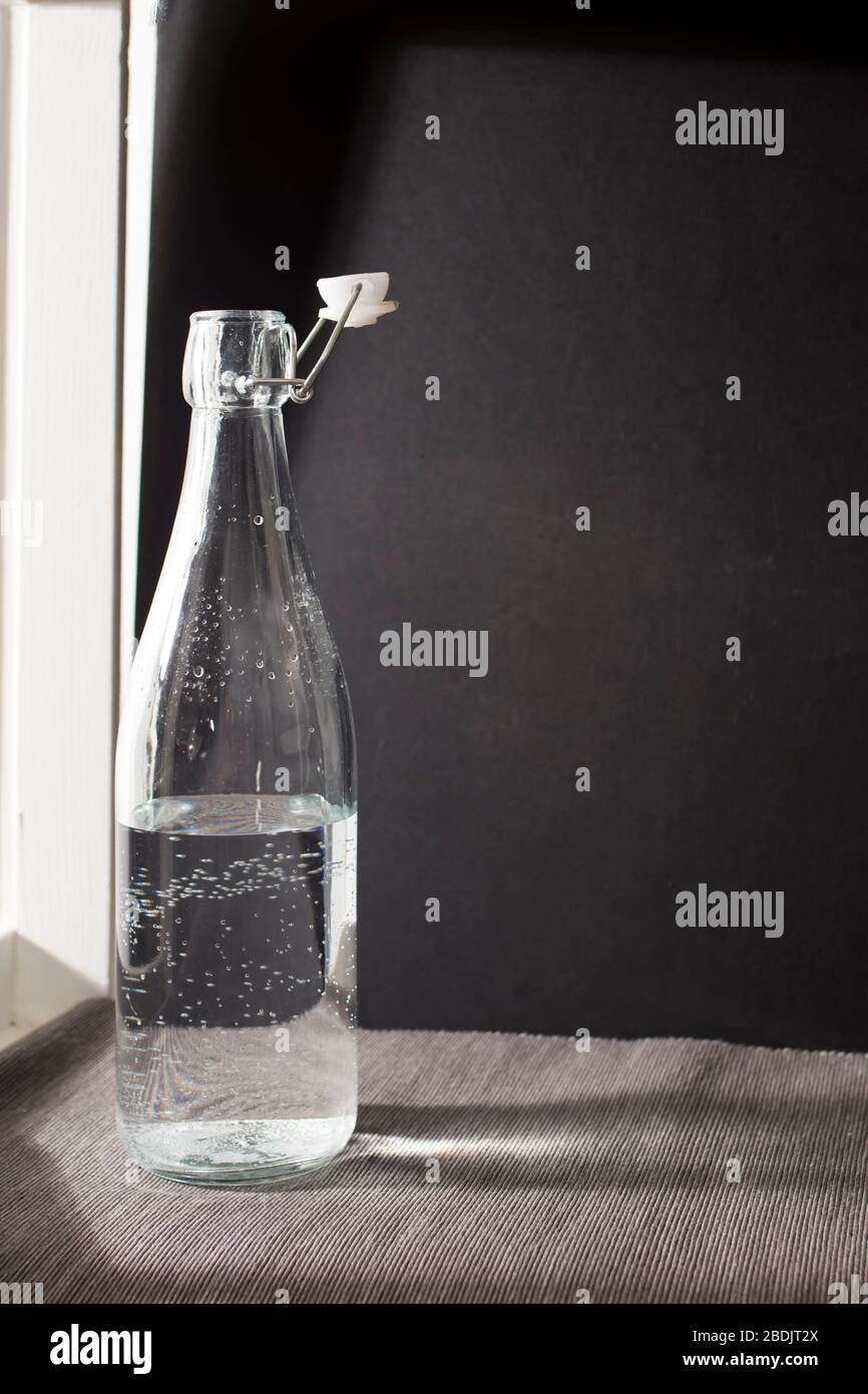 The transparent bottle with gas water on the black background. Copy ...