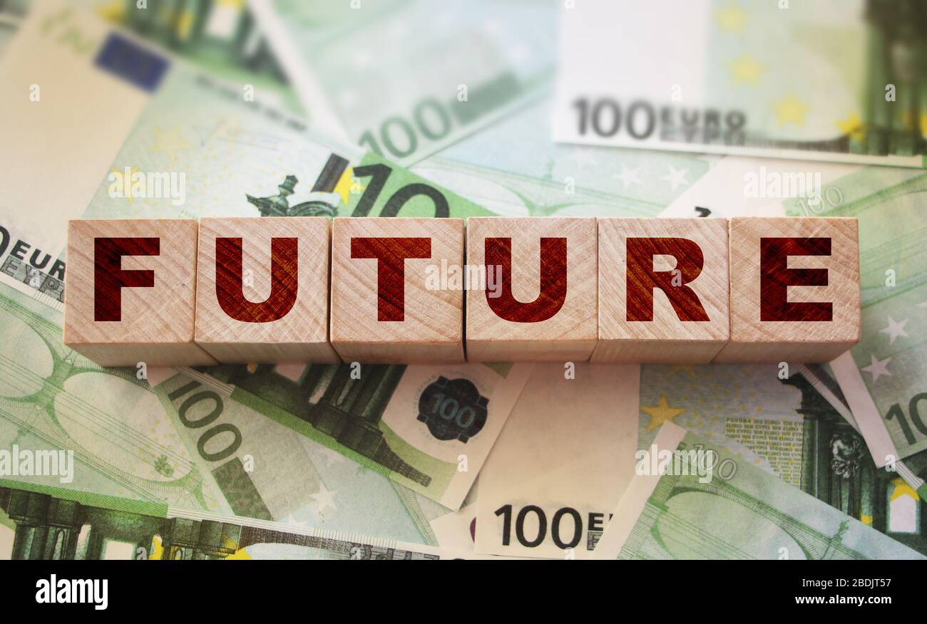 Future word letters on wooden cubes with hundred euro bills around ...