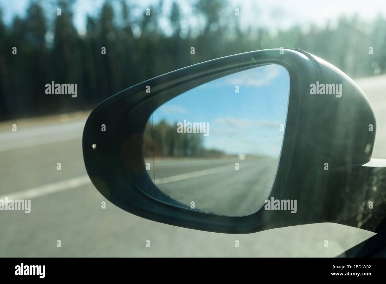 Rear view car mirror with defocused Road reflection. Selective focus ...