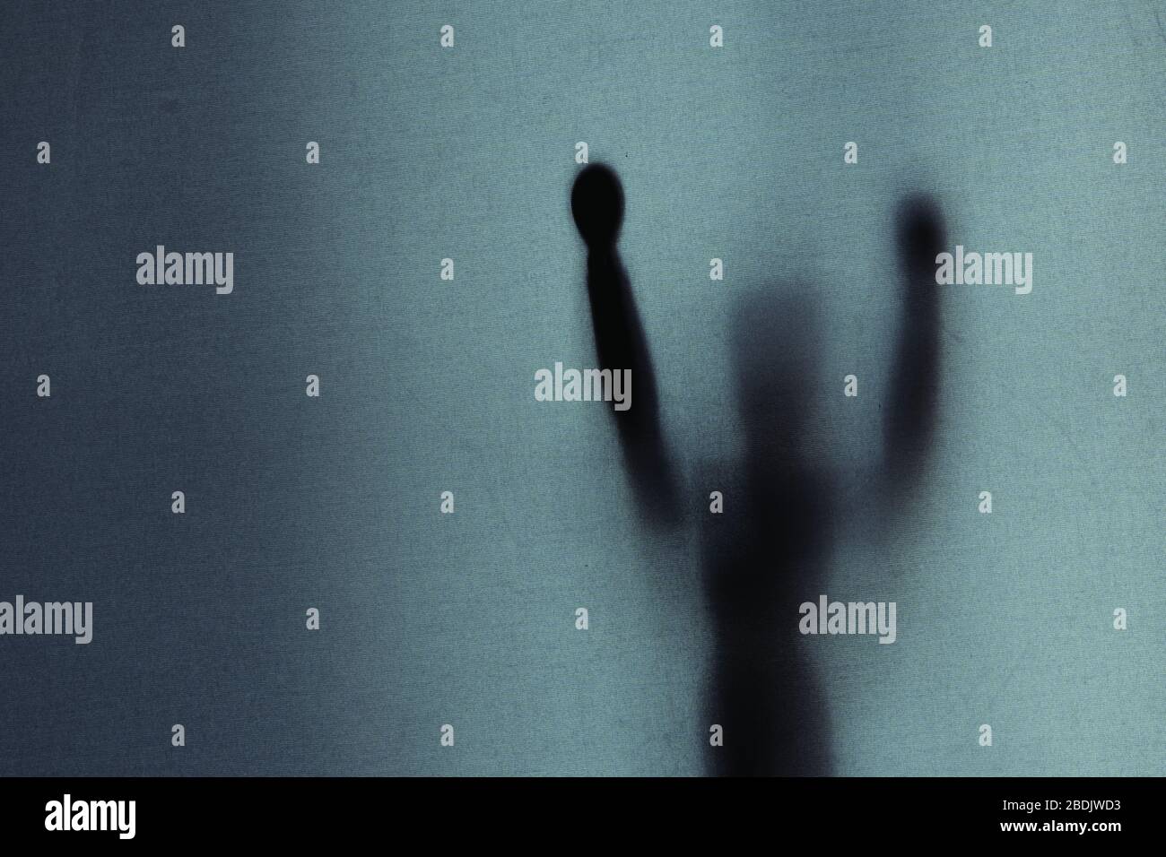 An artist wooden model. Hands up in the air. Shot through a semi ...