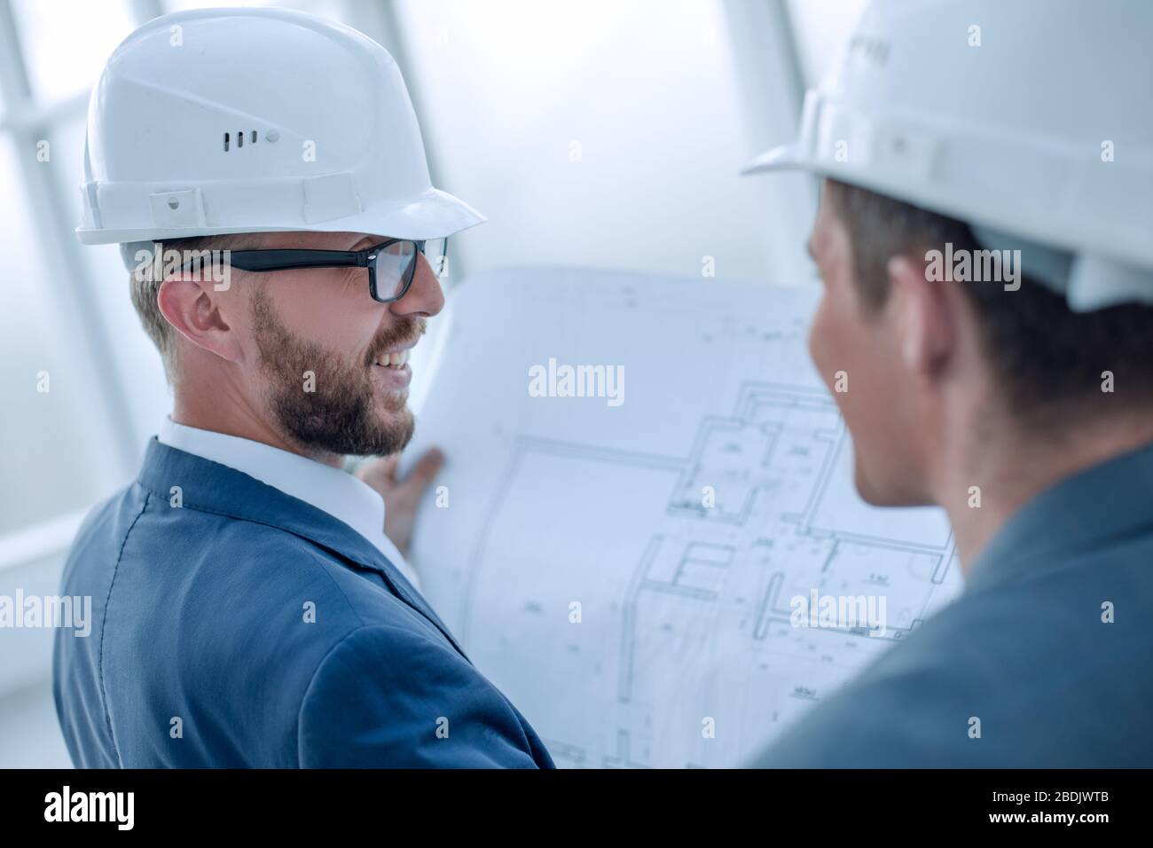 architect and engineer looking at blueprints of new project Stock Photo ...