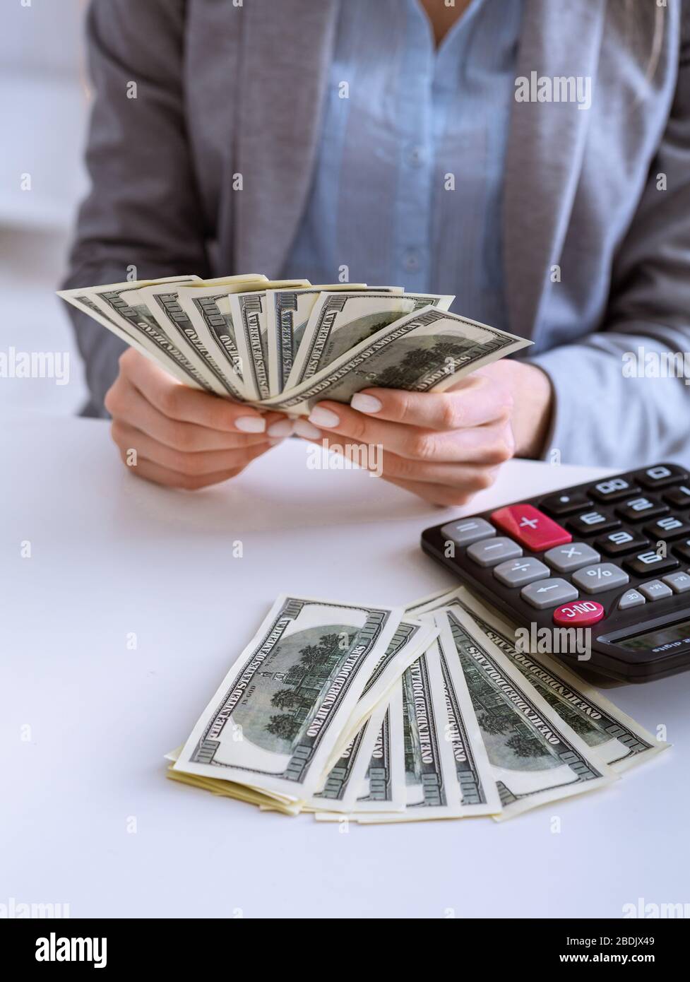 Budget allocation during quarantine. Female hands consider dollars ...