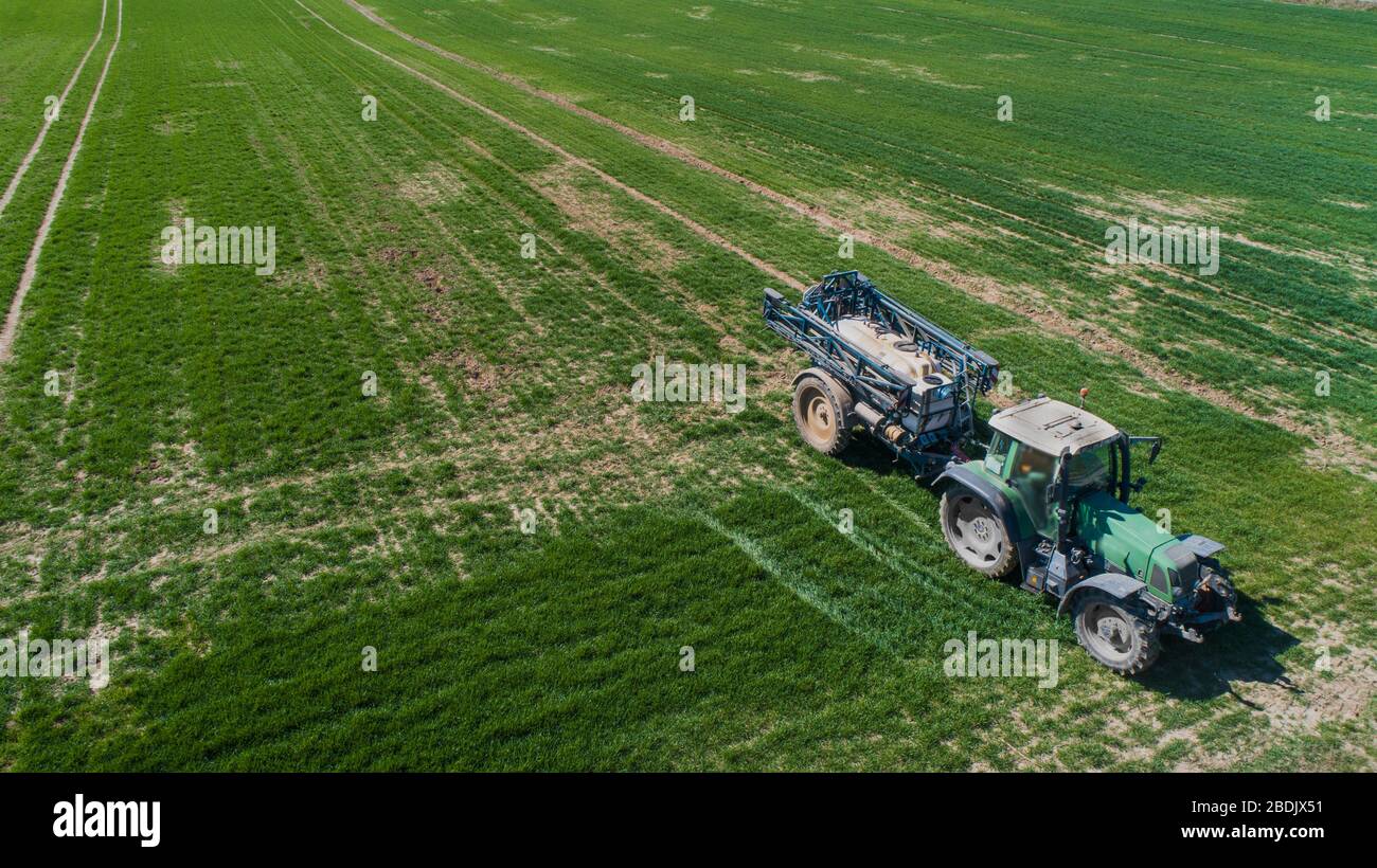 Agriculture Tractor Working in Field Spraying Herbicides Stock Photo ...