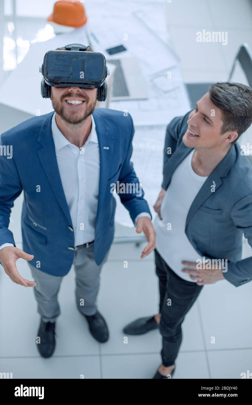 top view. smiling man looking through VR helmet Stock Photo - Alamy