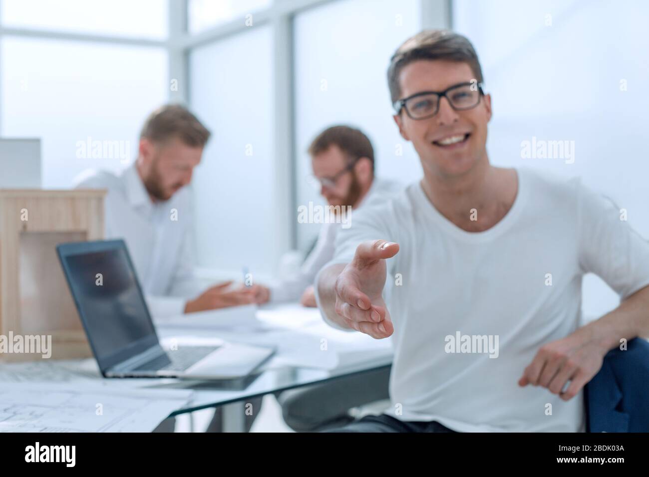 smiling architect greeting client with a handshake Stock Photo - Alamy