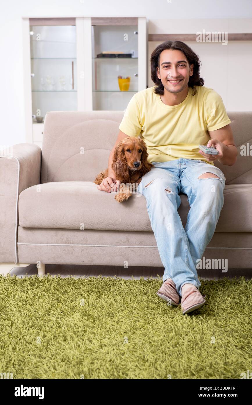 Young man with cocker spaniel Stock Photo - Alamy