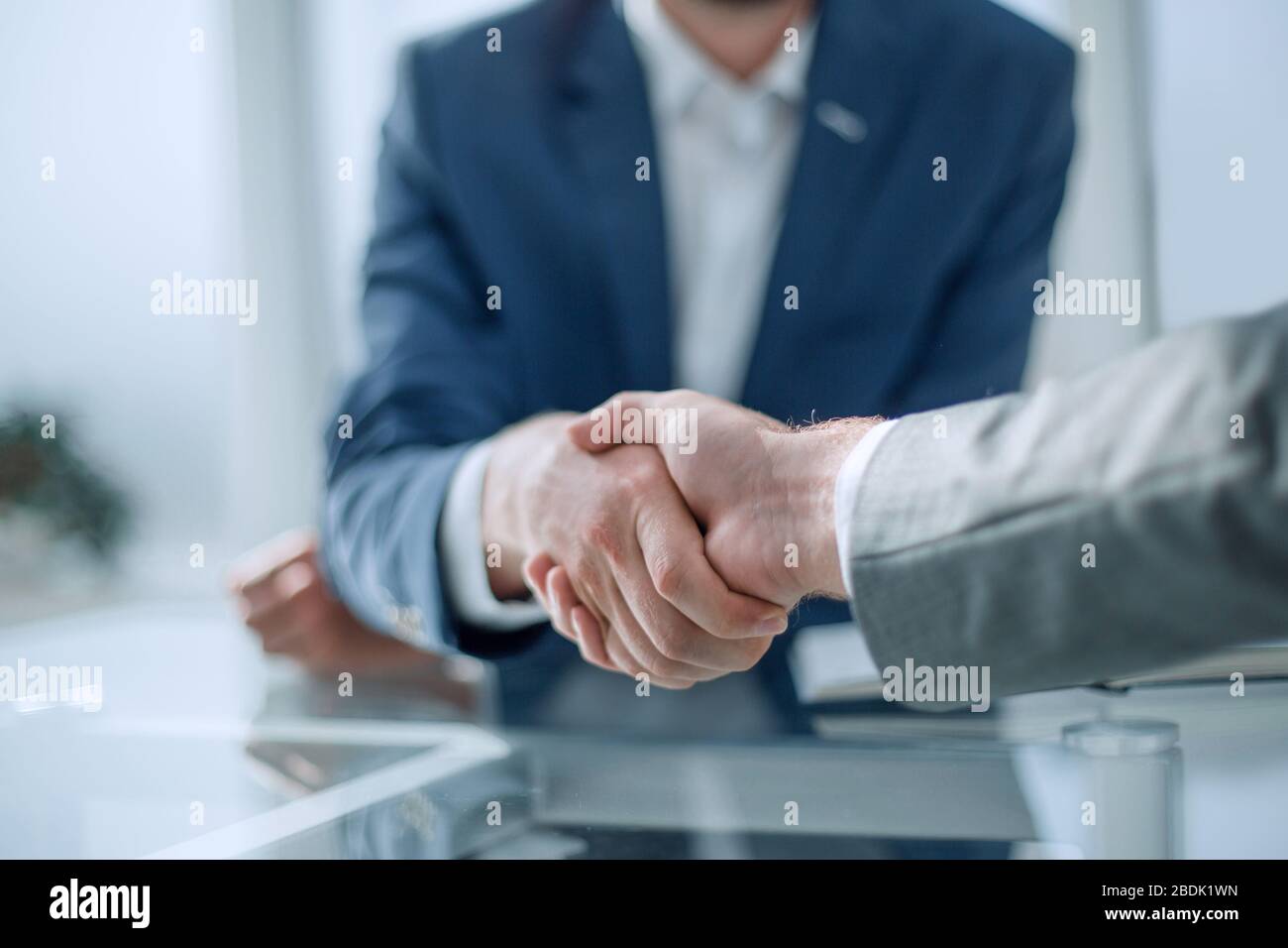 close up. business handshake over the office Desk Stock Photo - Alamy
