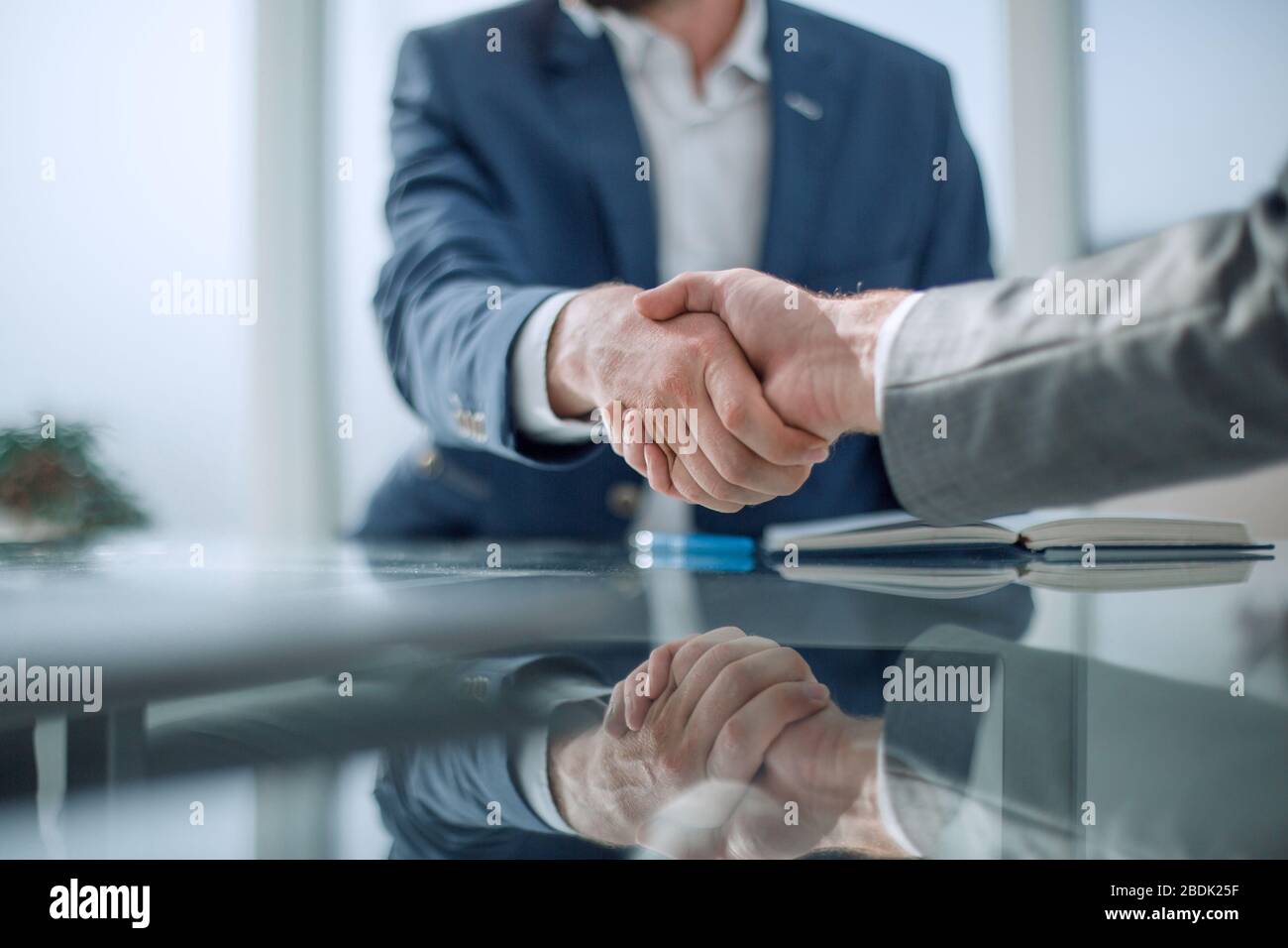 close up. business handshake over the office Desk Stock Photo - Alamy