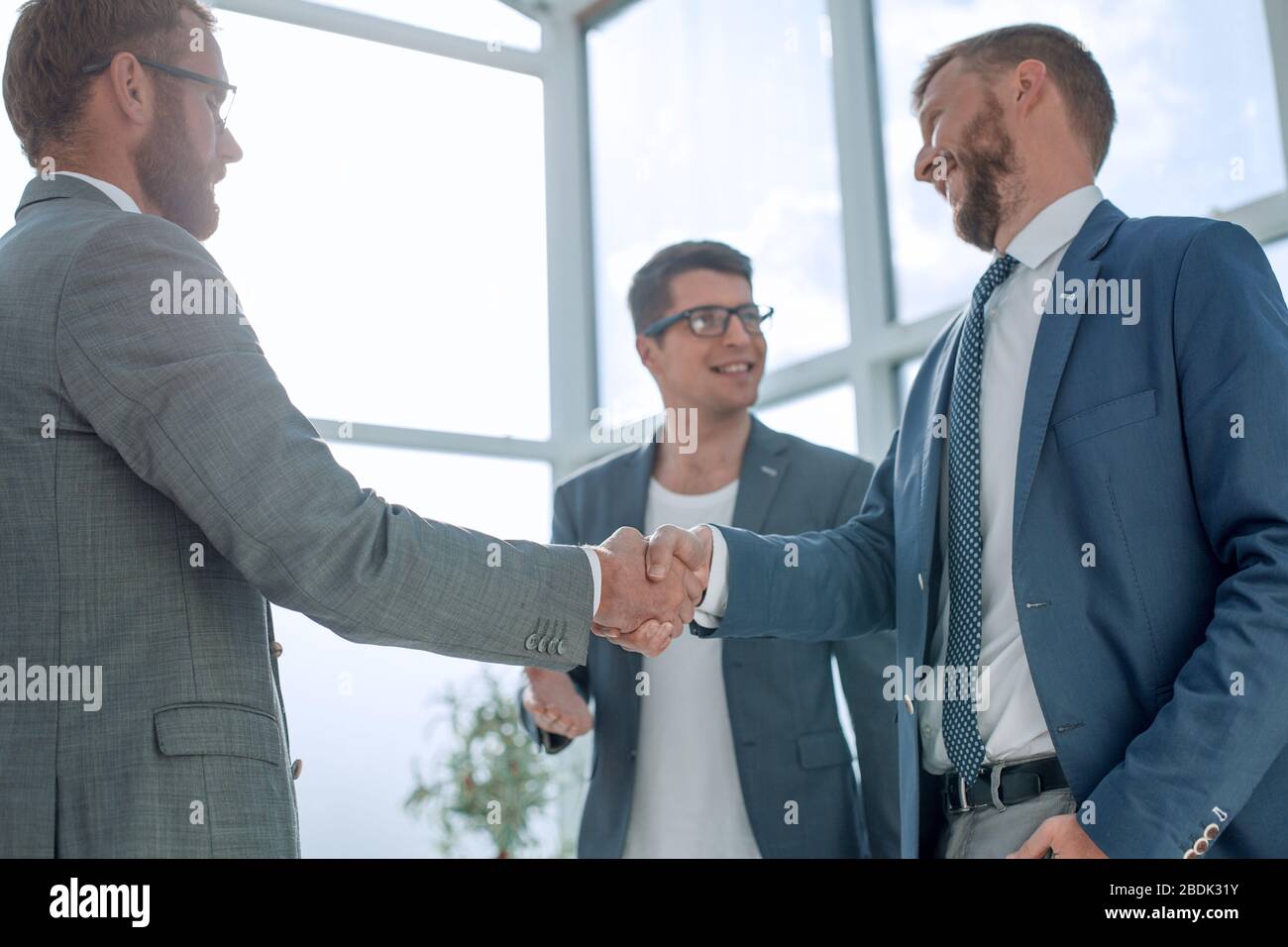 business people greet each other in the office lobby Stock Photo - Alamy