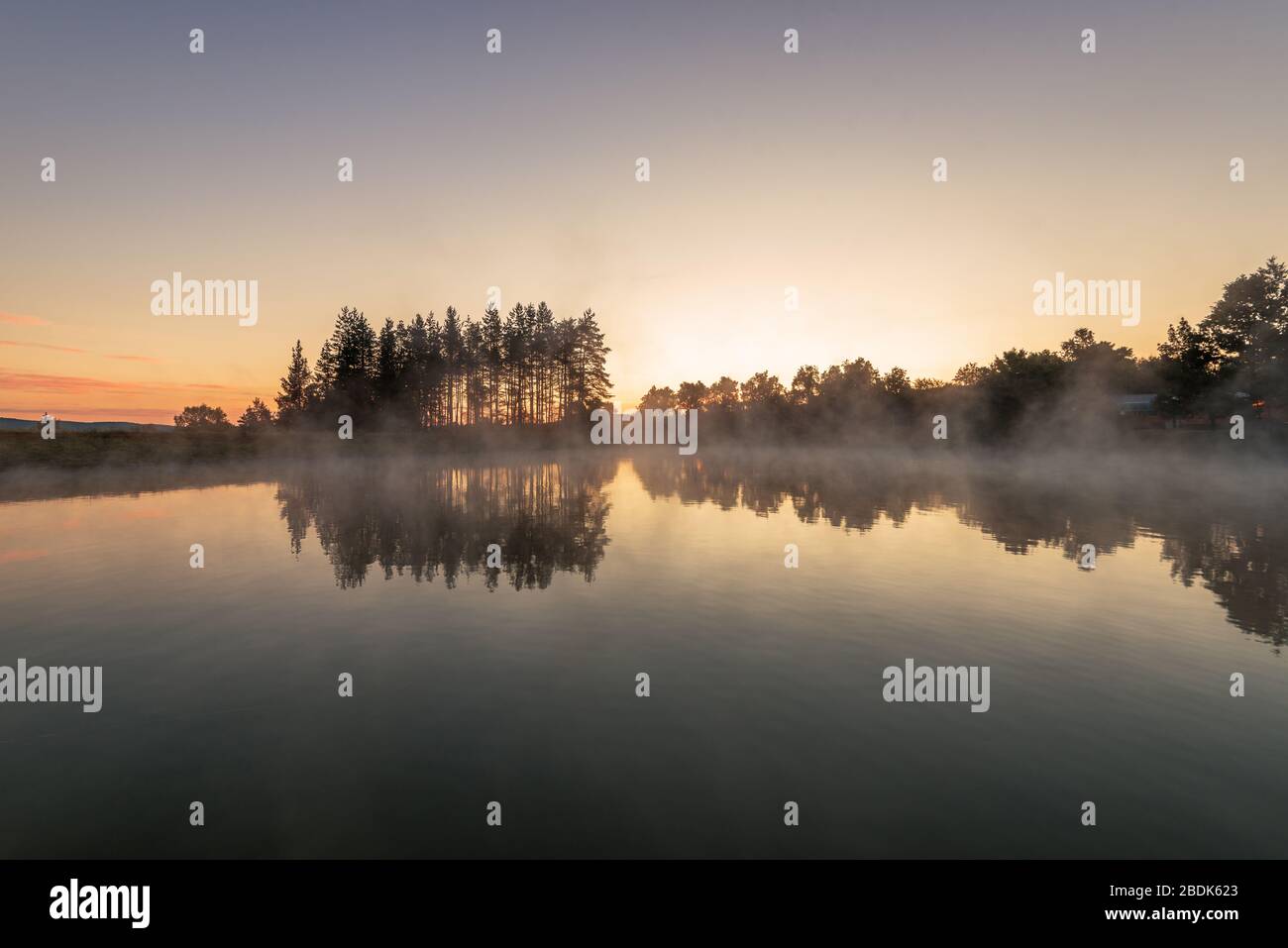 Morning fog on the forest lake, sunrise shot Stock Photo - Alamy