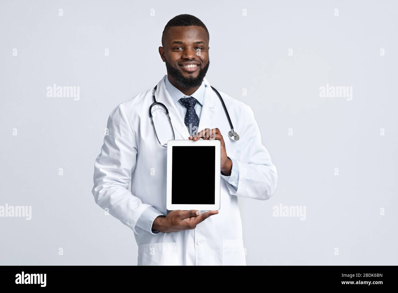 Positive black doc recommending online application for healthcare Stock ...