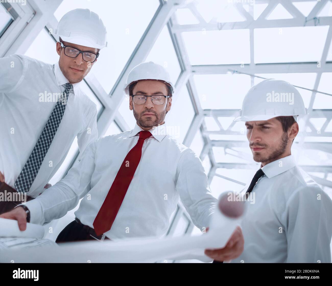 three architects discussing sketches for a new project Stock Photo - Alamy