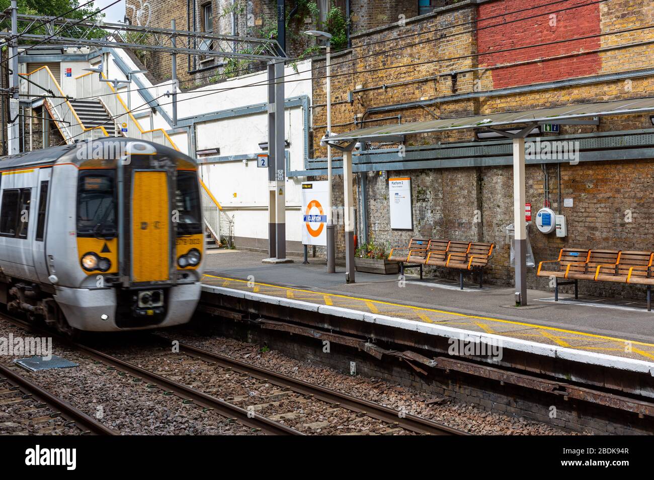 Passengers wait for their overground train at Clapton Railway station ...
