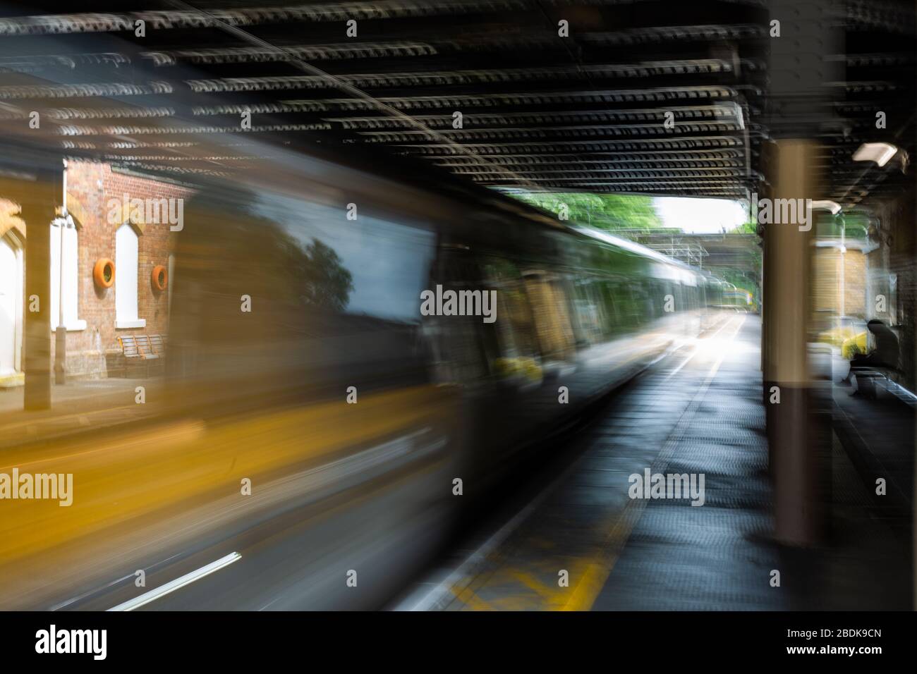 Passengers wait for their overground train at Clapton Railway station ...
