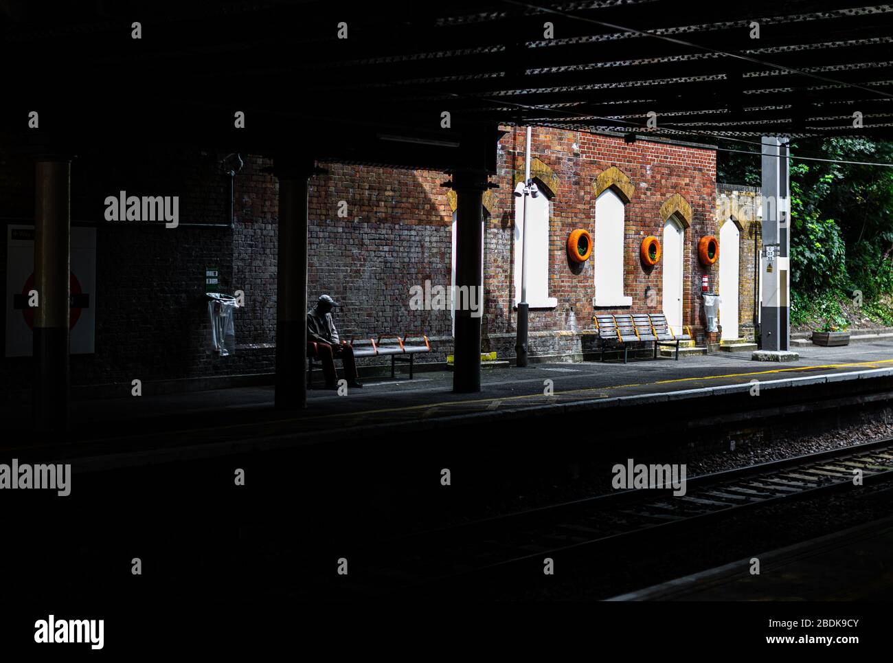 Passengers wait for their overground train at Clapton Railway station ...