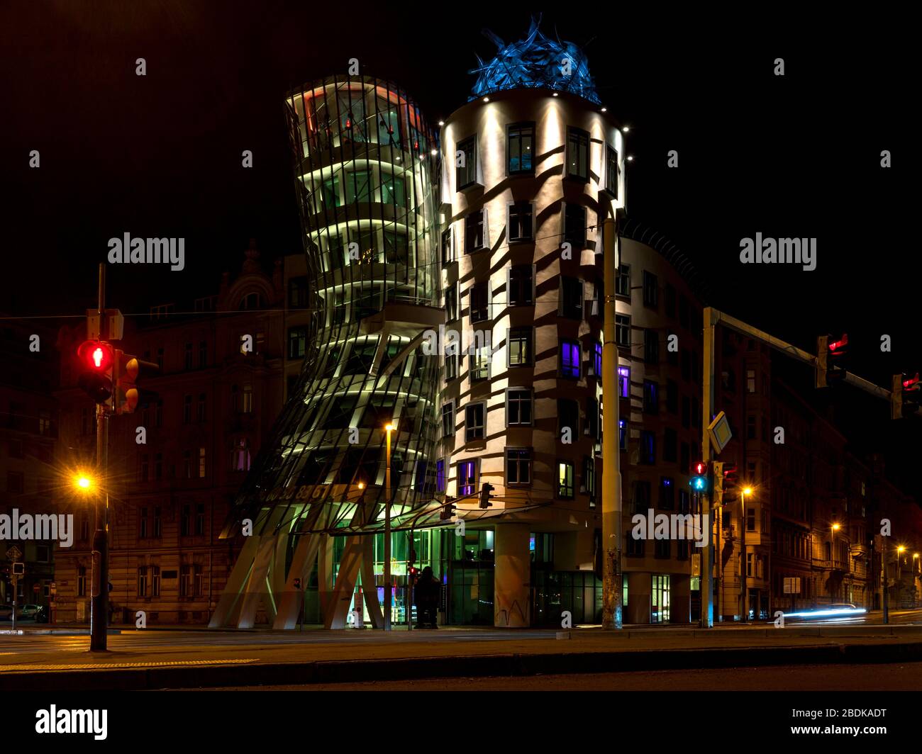 The illuminated Dancing House building in Prague at night. The building ...