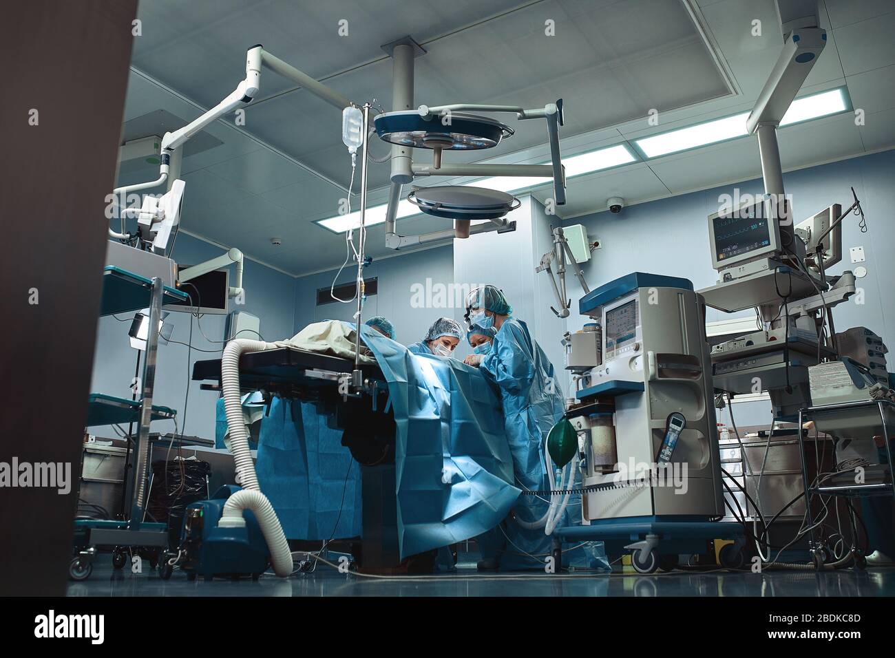 Surgical team operating on patient in theater in hospital Stock Photo ...