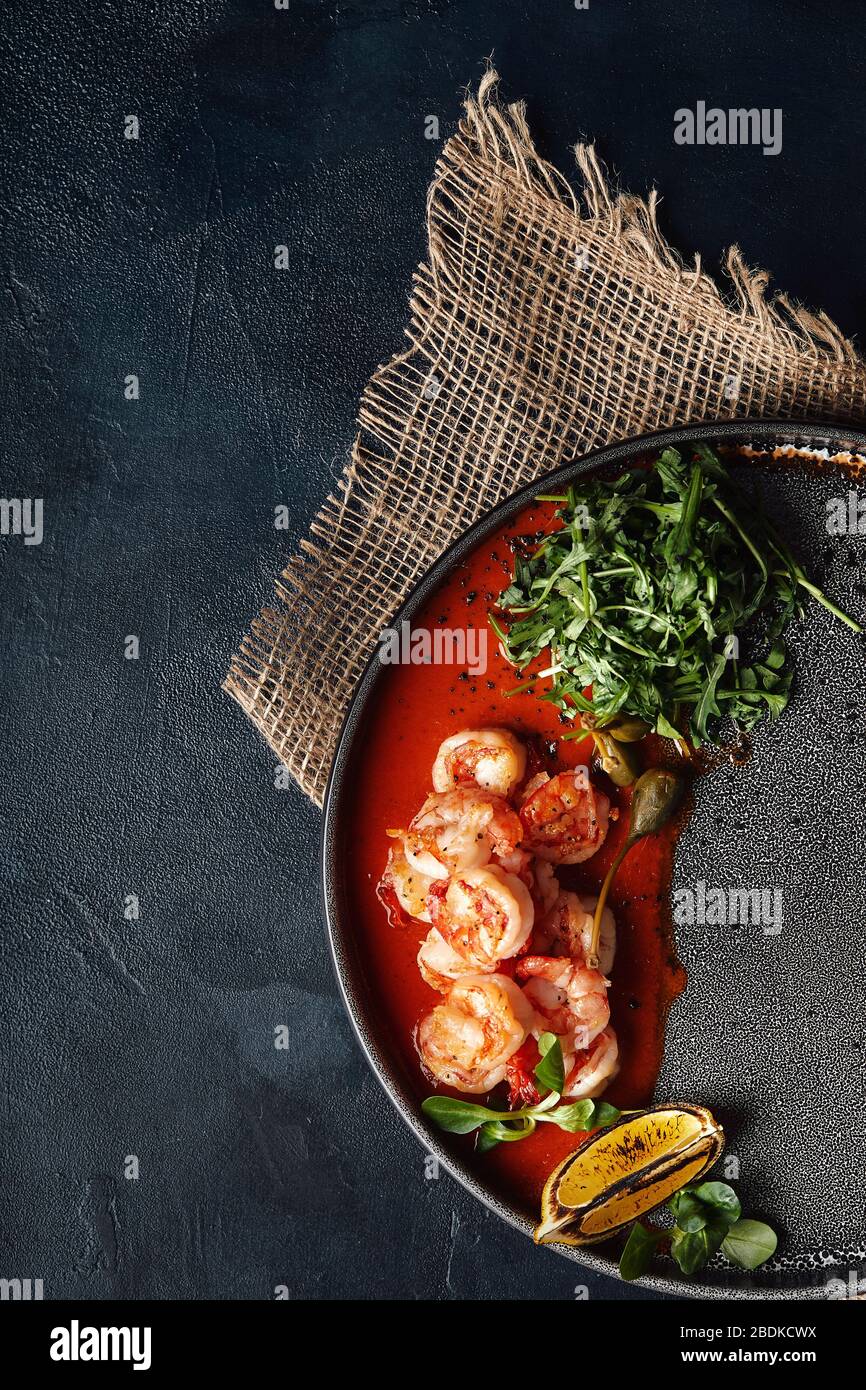 Grilled tiger crackers beautifully canned on a plate with tomato sauce ...