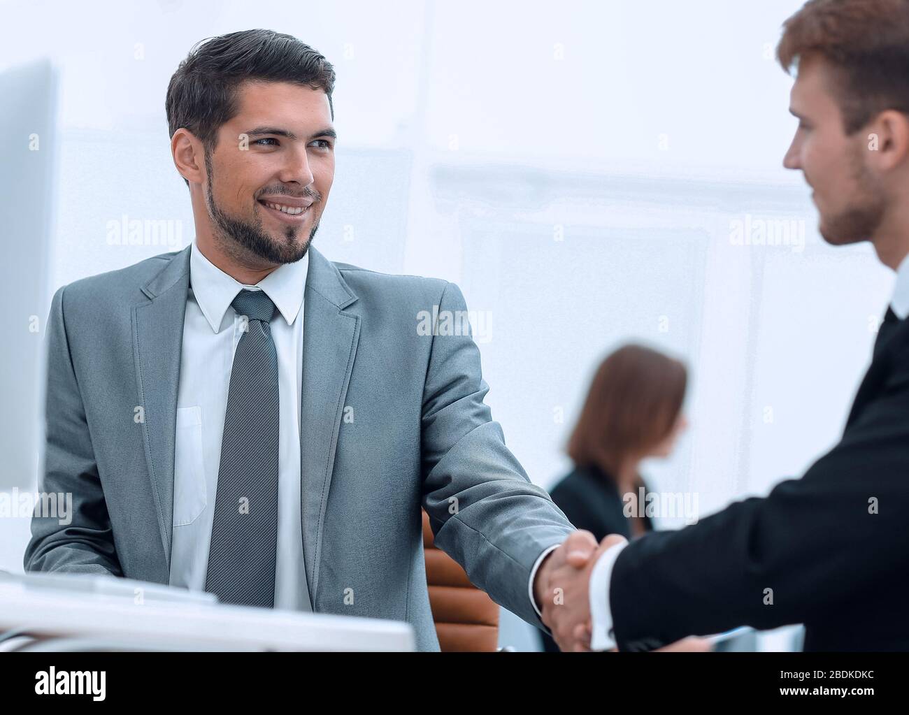 handshake Manager and the client in the office Stock Photo - Alamy
