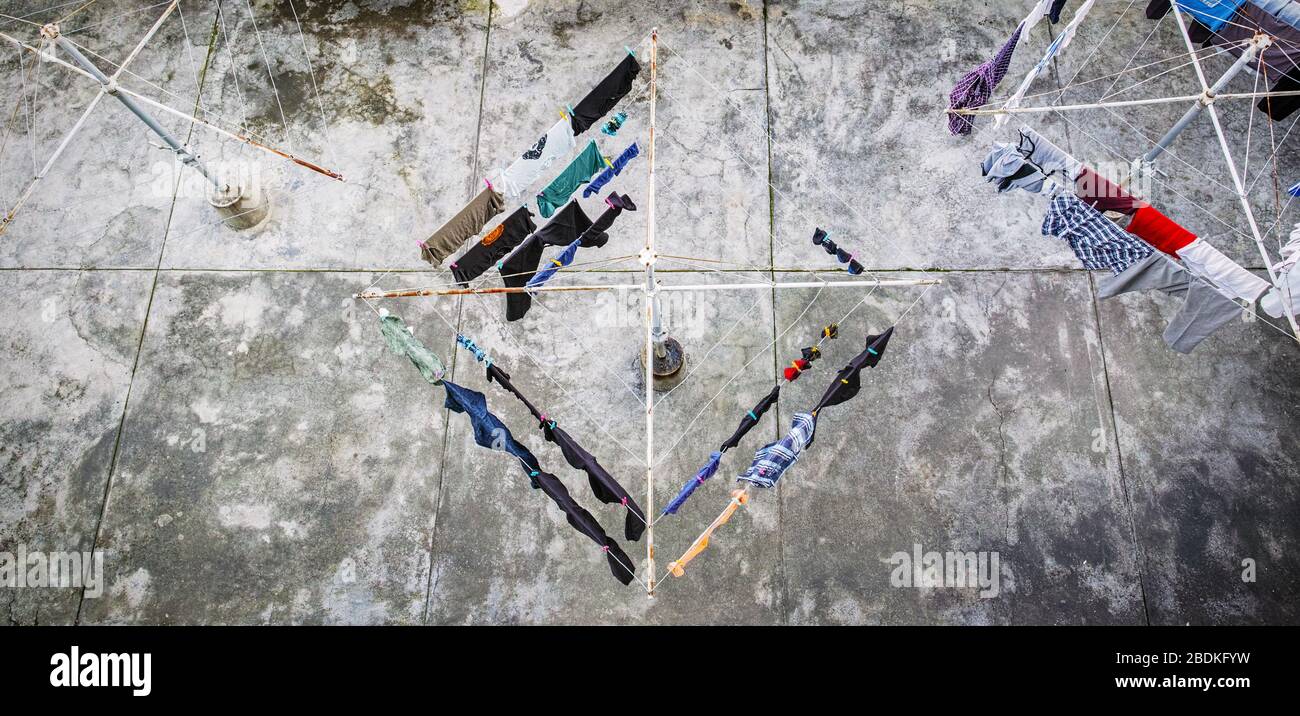 Overhead view of old rotary washing lines with clothes hanging in a ...