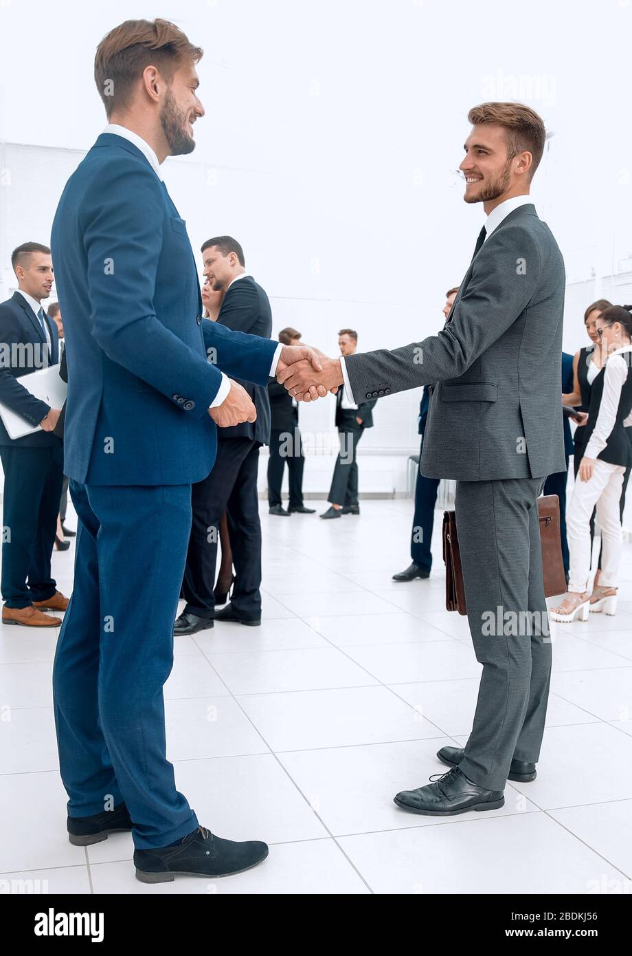 handshake of business partners on the background of business team Stock ...