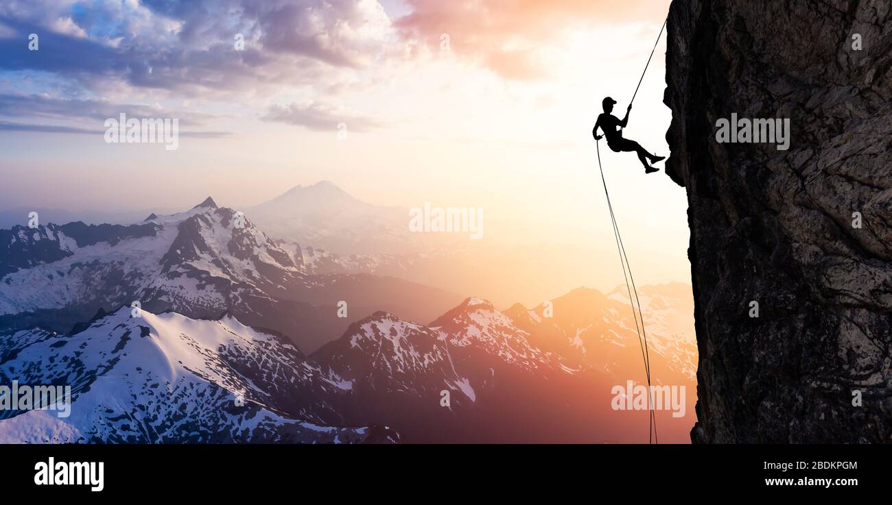 Silhouette Rappelling from Cliff Stock Photo - Alamy