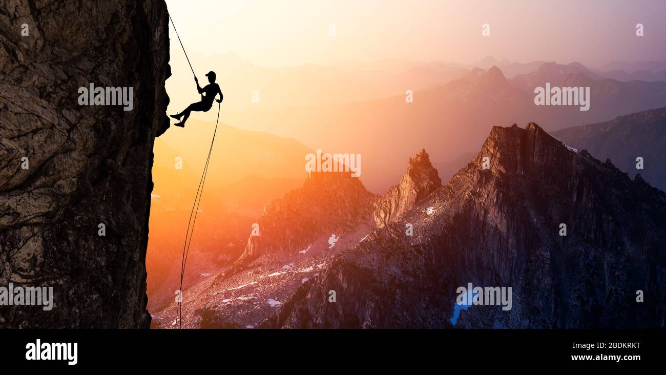 Silhouette Rappelling from Cliff Stock Photo - Alamy